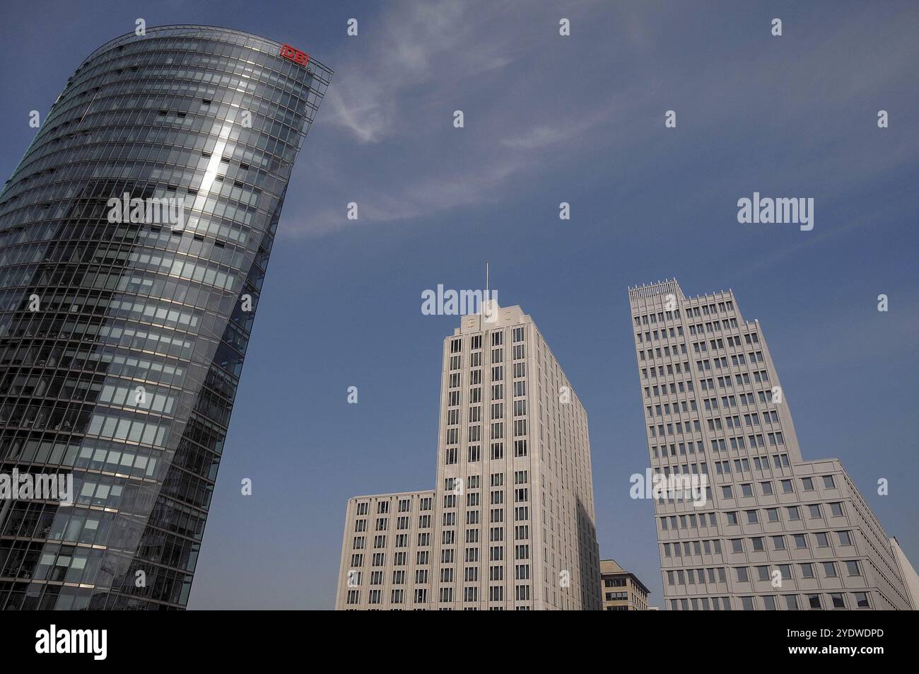 Two modern high-rise buildings with glass facades against a blue sky ...