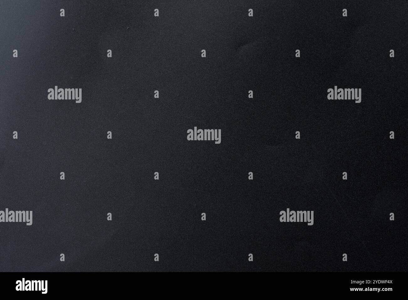 Black rough textured background lit with dim light at the angle Stock ...