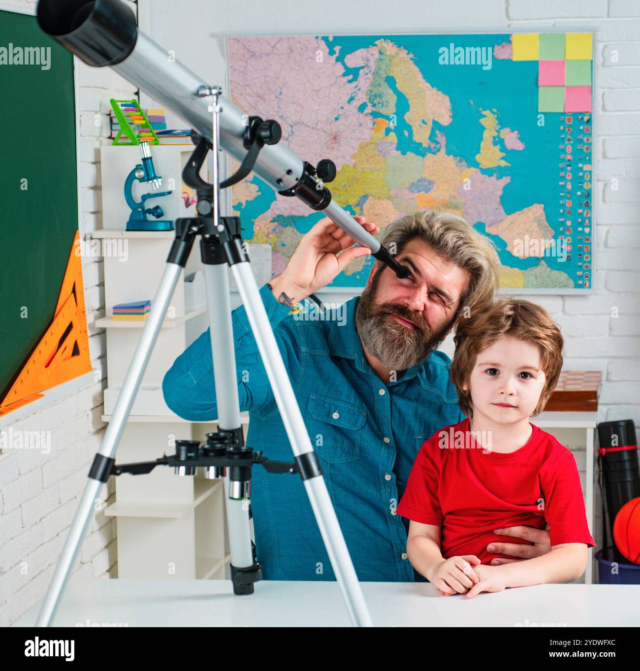 Pupil watching stars with a teacher. Astronomy telescope. Father teaching son Stock Photo - Alamy