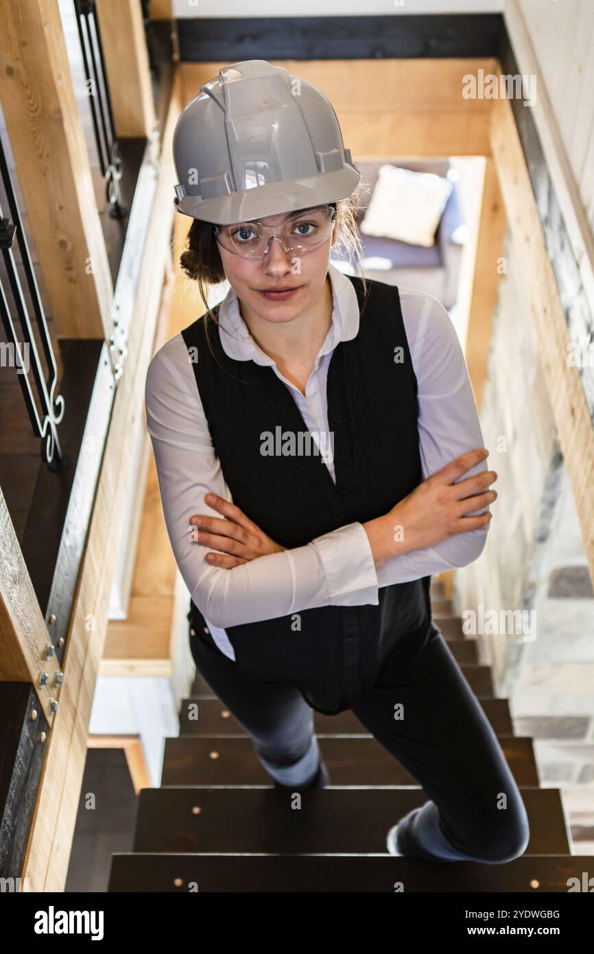 Young attractive caucasian woman with crossed arms pose, standing down ...