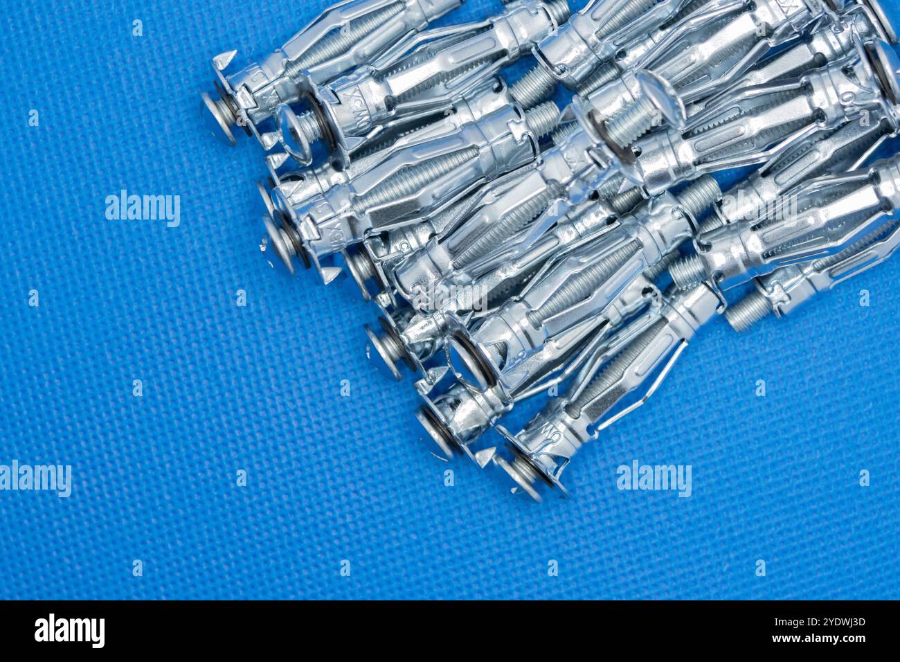 Group of metal nylon toggle bolts is lying on a blue surface Stock ...