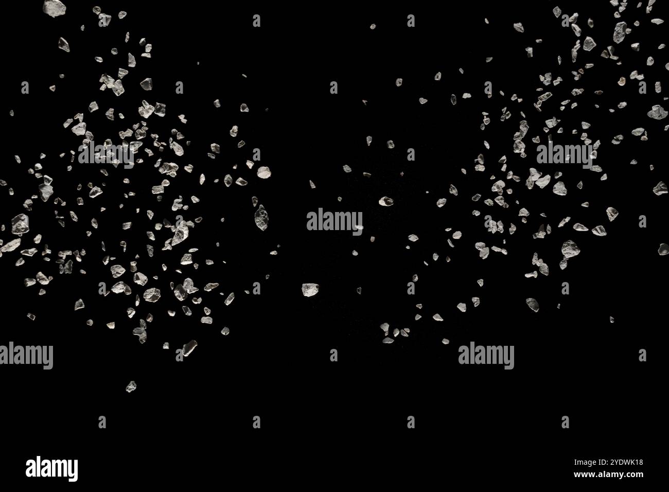 Split debris of stone exploding against black background Stock Photo ...