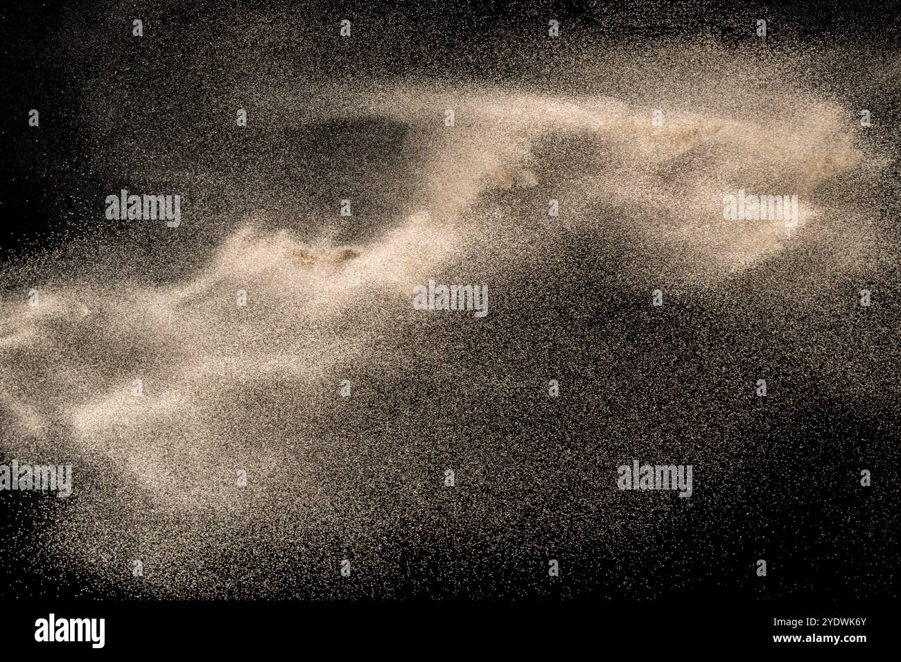 Dry river sand explosion. Golden colored sand splash against black ...