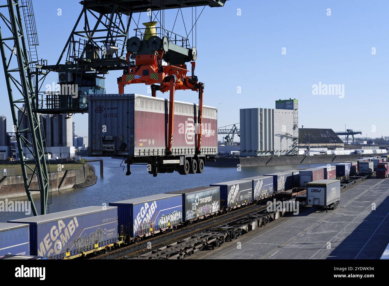 Loading a lorry trailer with a gantry crane onto railway wagons in ...