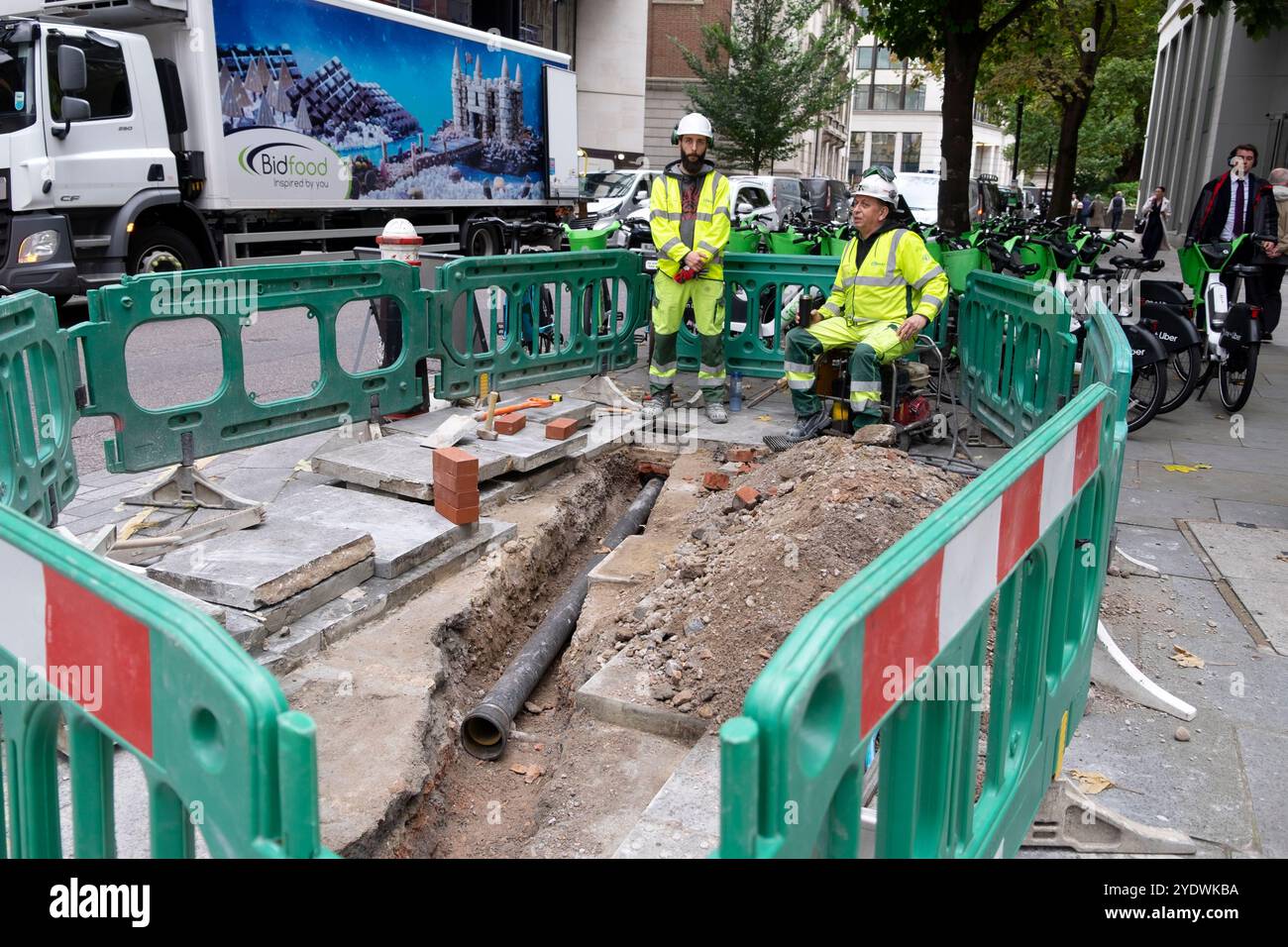 Utilities worker workers workmen working, barriers and black utility ...