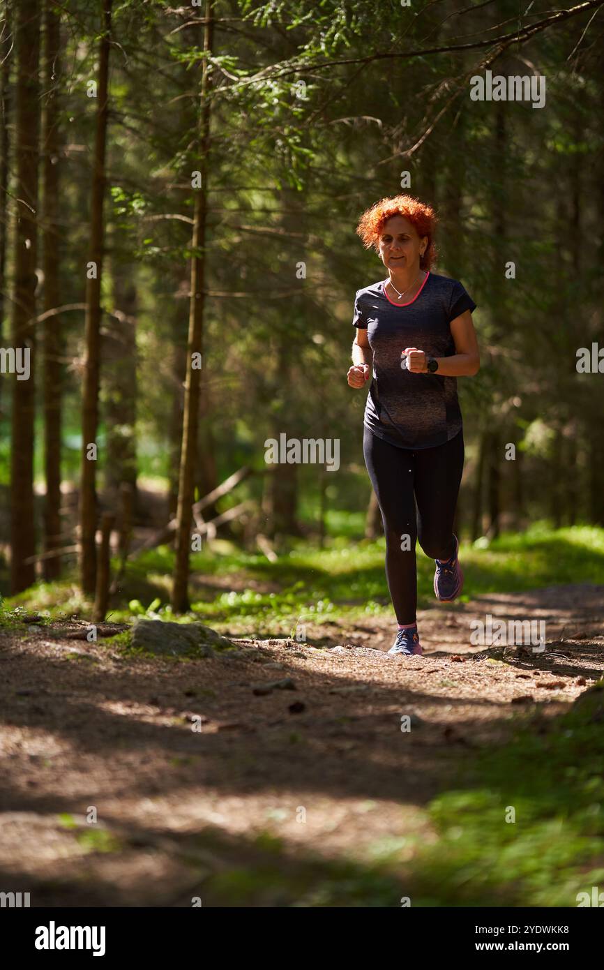 Female athlete running through forest hi-res stock photography and ...