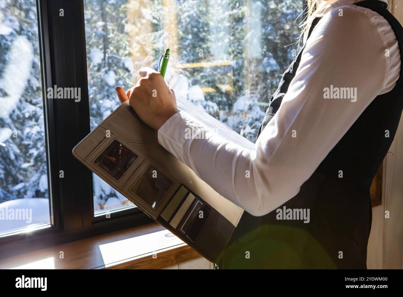 Close up on an unrecognizable inspector woman using a clipboard to ...