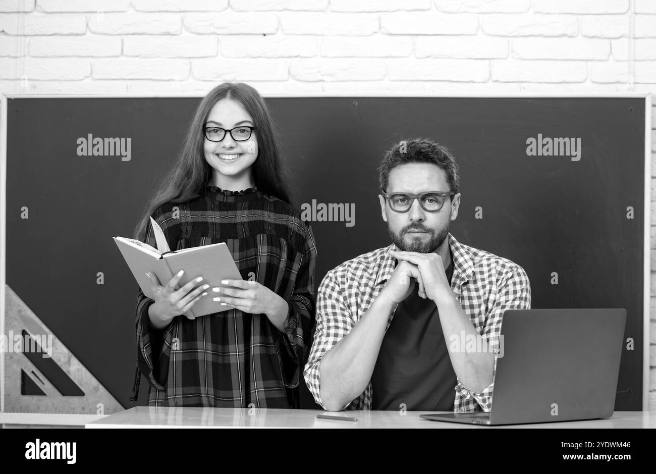 Teacher explains lesson to school child. Elementary school kids ...