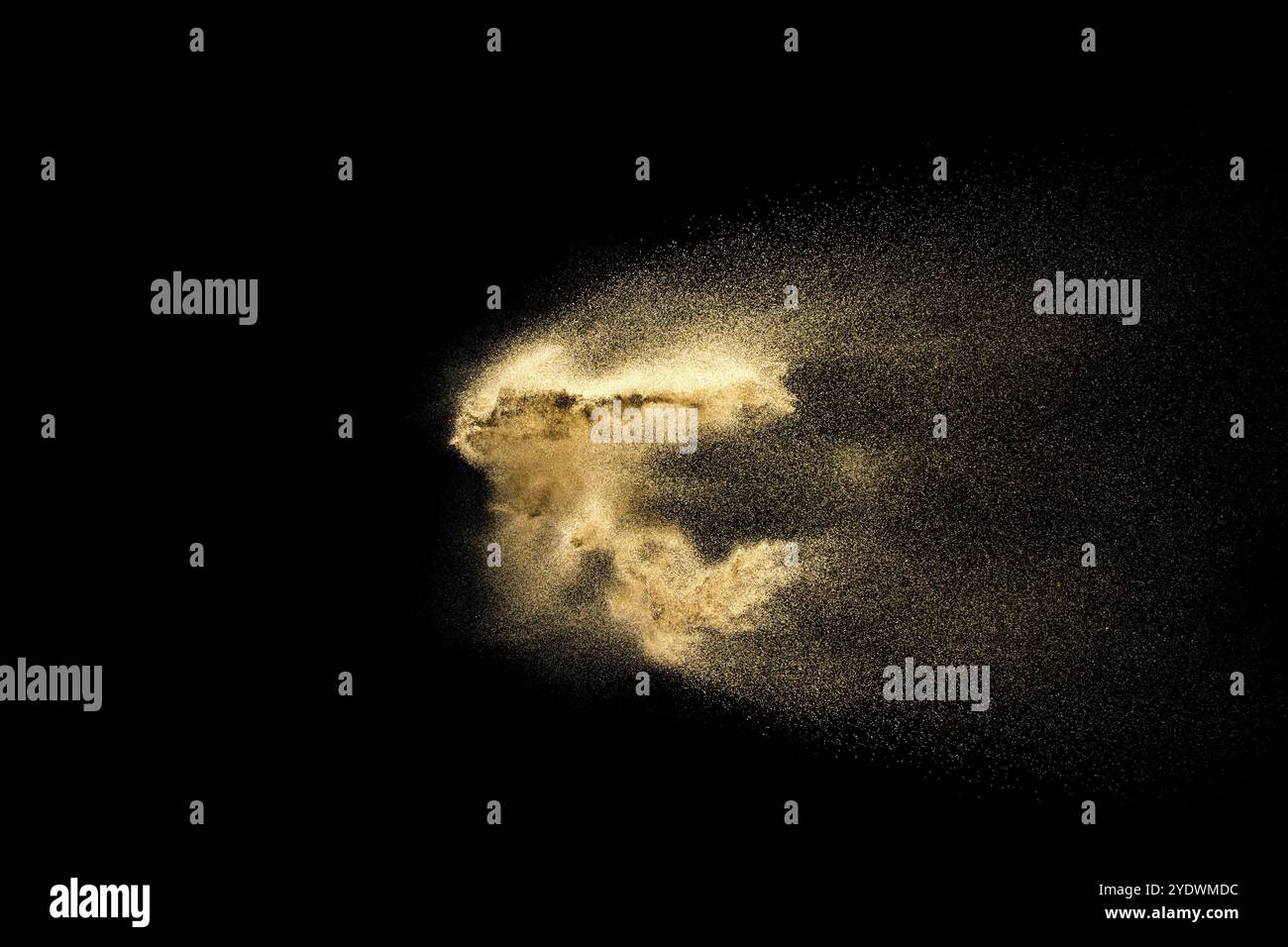 Abstract sand cloud. Golden colored sand splash against dark background ...