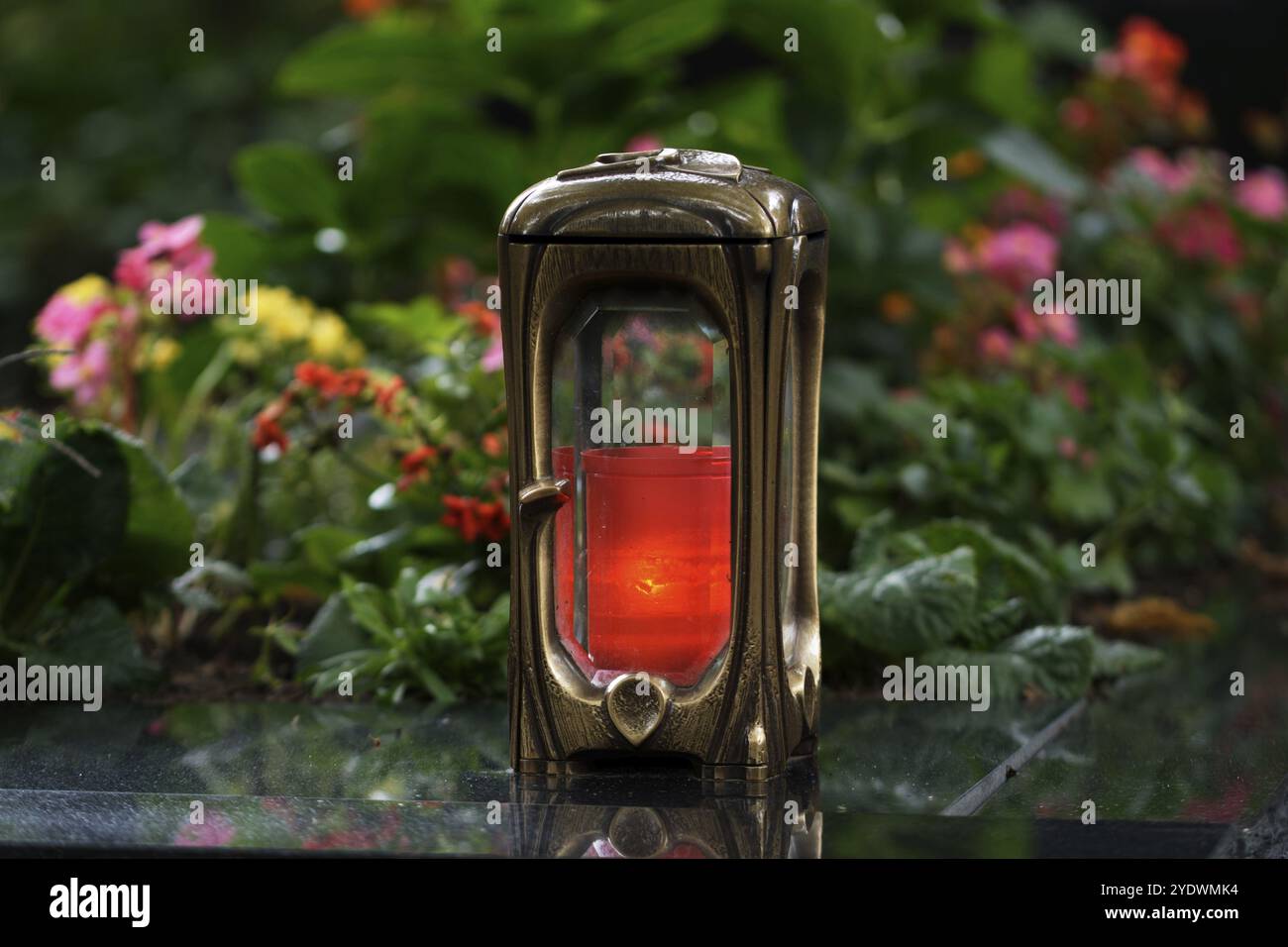 Metal grave lantern with burning candle in front of flowers on a grave Stock Photo - Alamy