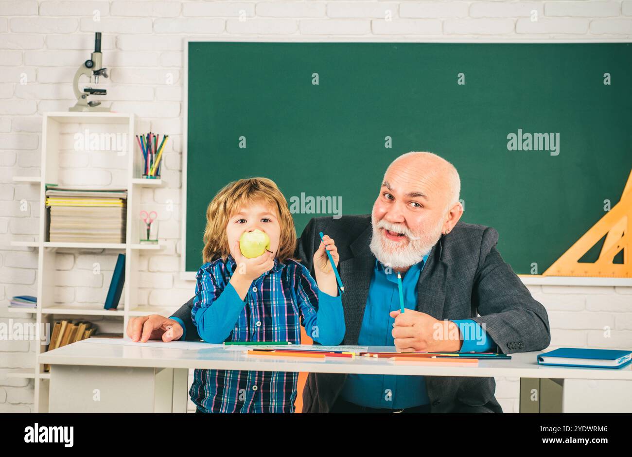 Individual teaching. Portrait of senior teacher and little boy kid ...
