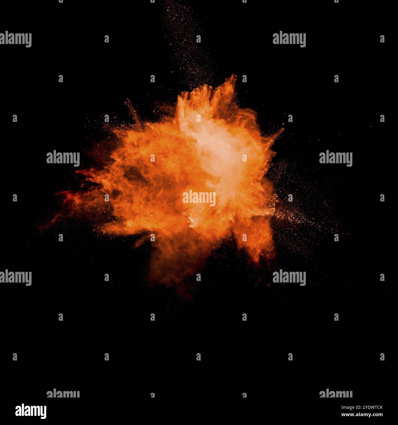 Orange powder explosion on black background. Orange color dust splash ...