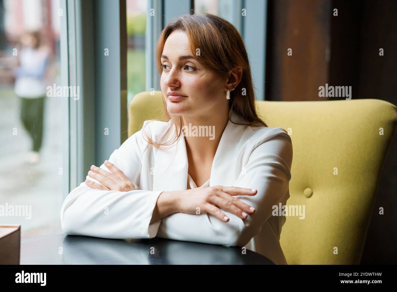 Reflective Woman in a Modern Cafe Setting Stock Photo - Alamy
