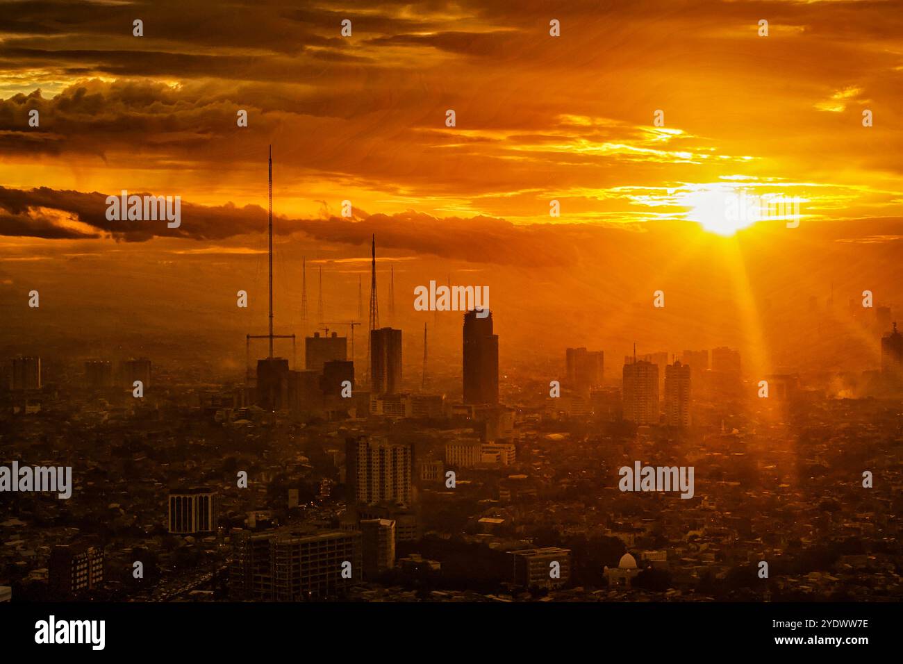 Orange sunset over cityscape at dusk, Jakarta, Indonesia Stock Photo ...