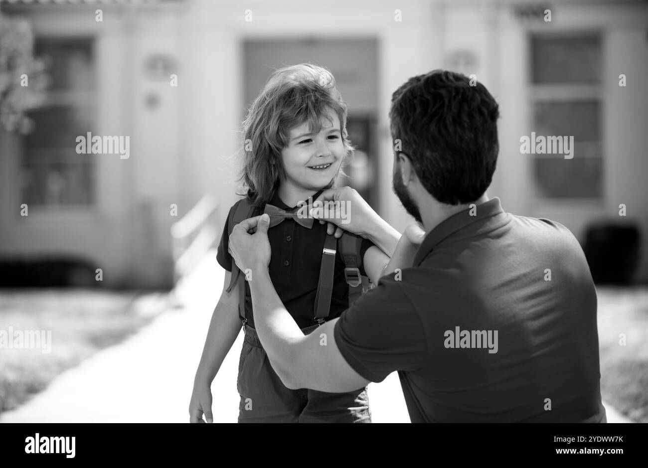 Father helping son ready to school. Father supports and motivates son ...