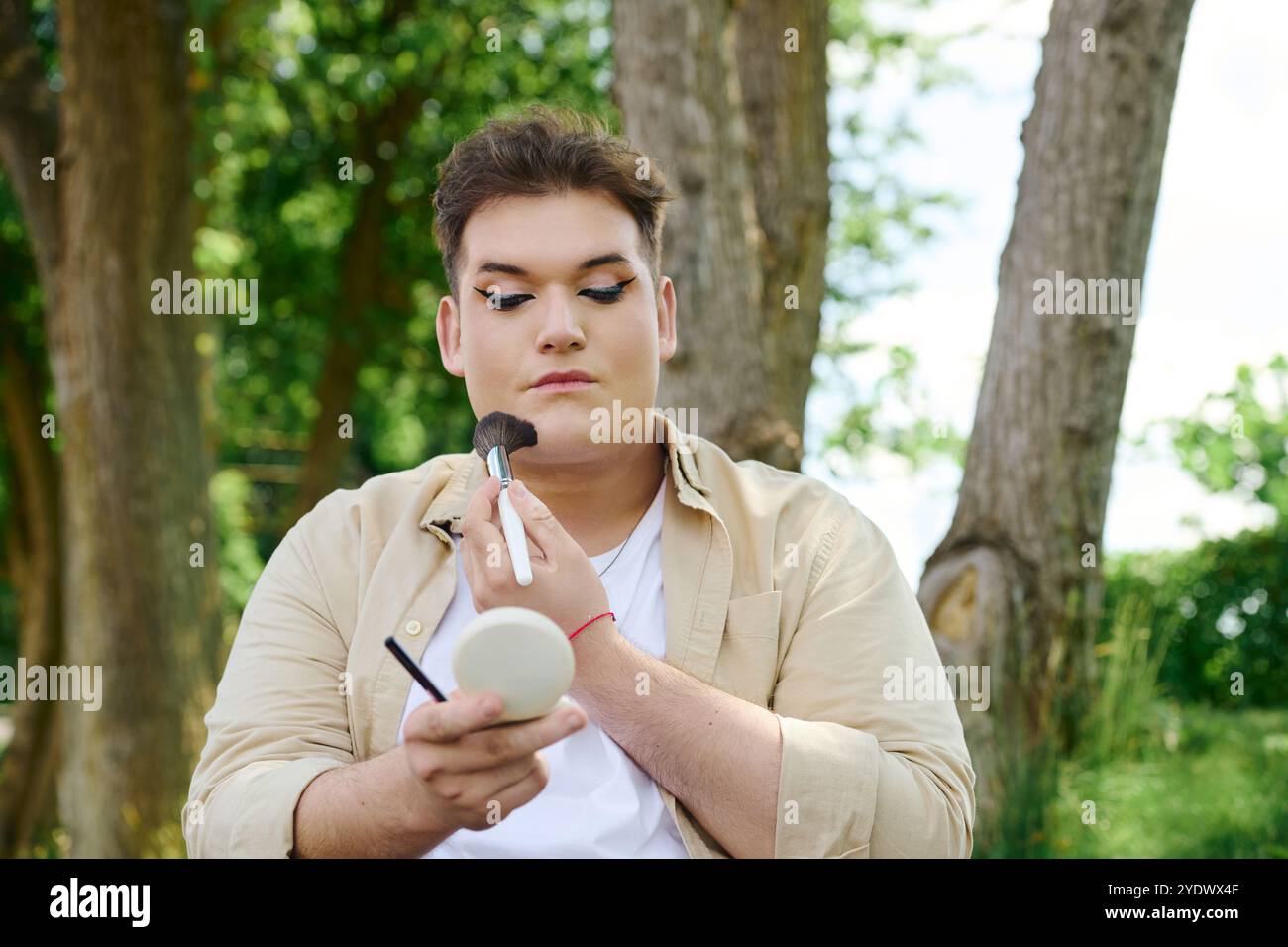 A queer person focuses on makeup application while surrounded by lush ...