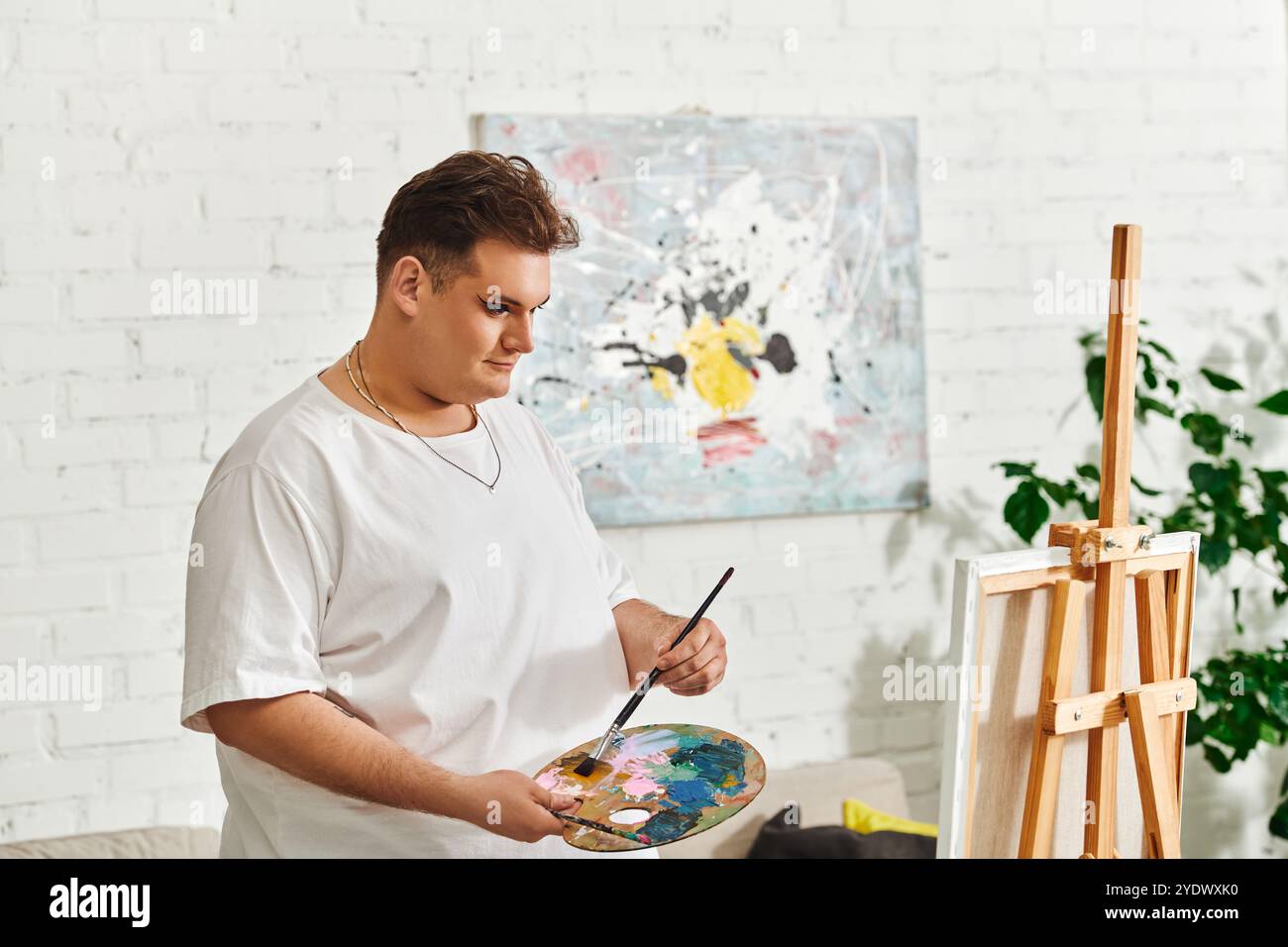 A unique individual stands in a lively studio, ready to create an ...