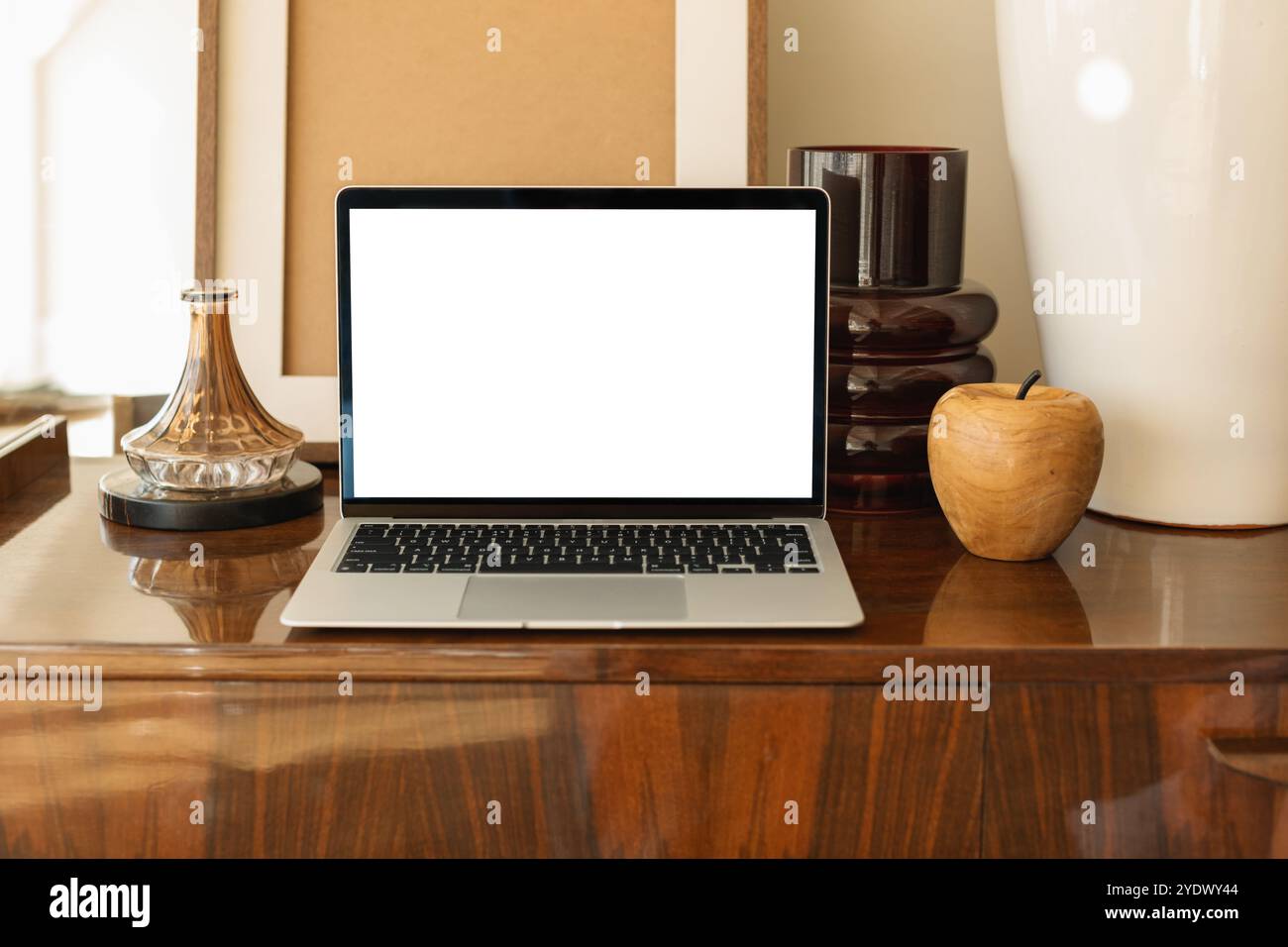 Close-up of an open laptop computer with a blank screen on a sideboard ...