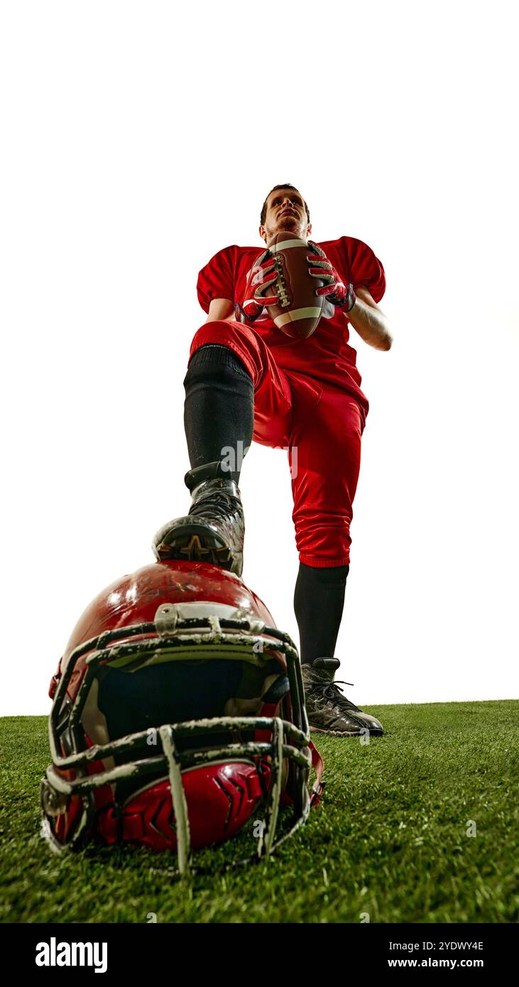 Champion. Bottom view of man, American football player in red uniform ...