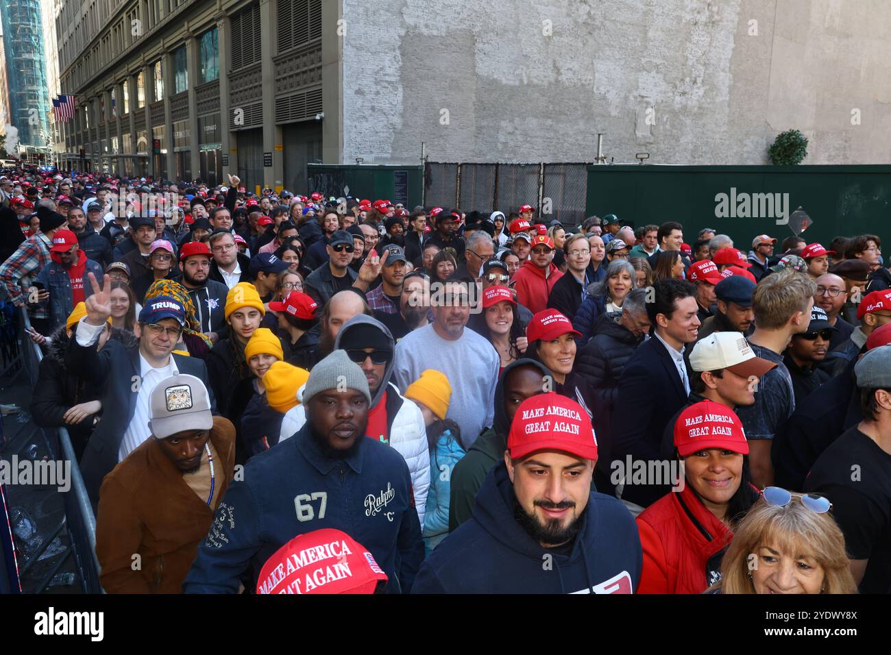 People line up behind police barricades on E. 32nd Street waiting to ...
