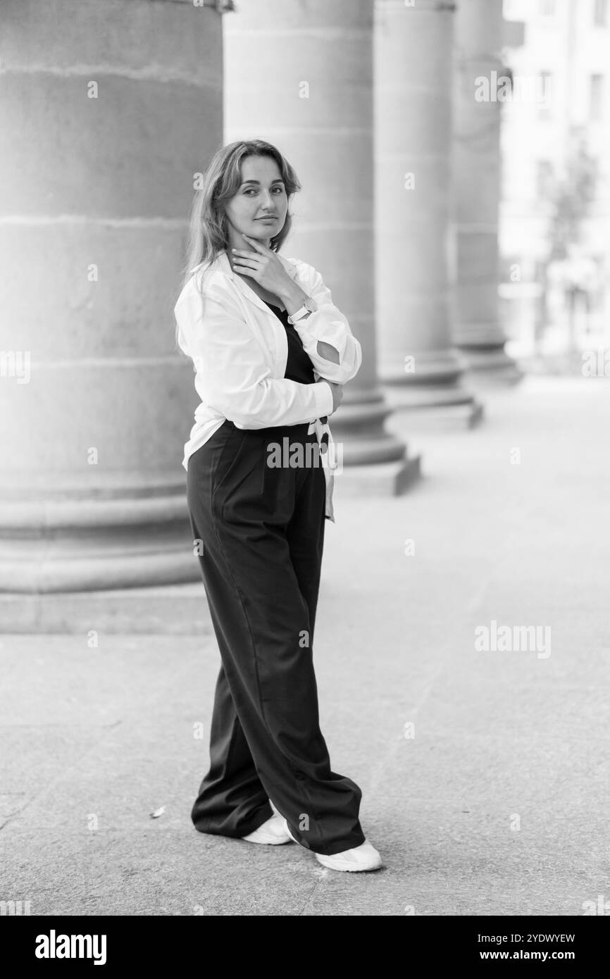 Elegant Fashion Pose Against Architectural Columns in Black and White ...