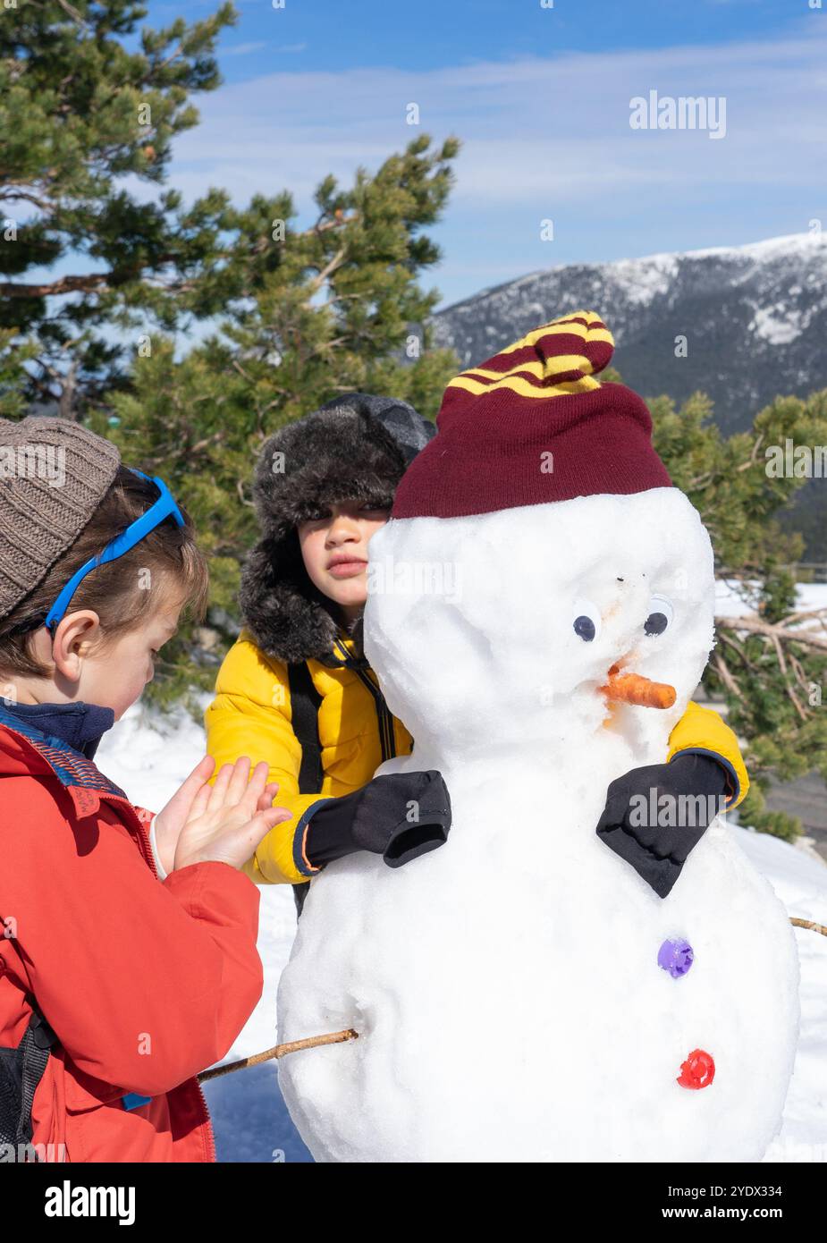Children building a snowman hi-res stock photography and images - Alamy