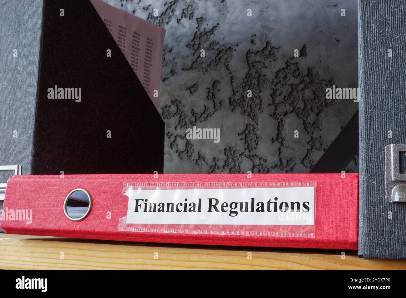 Financial regulations folder on shelf symbolizing compliance Stock ...