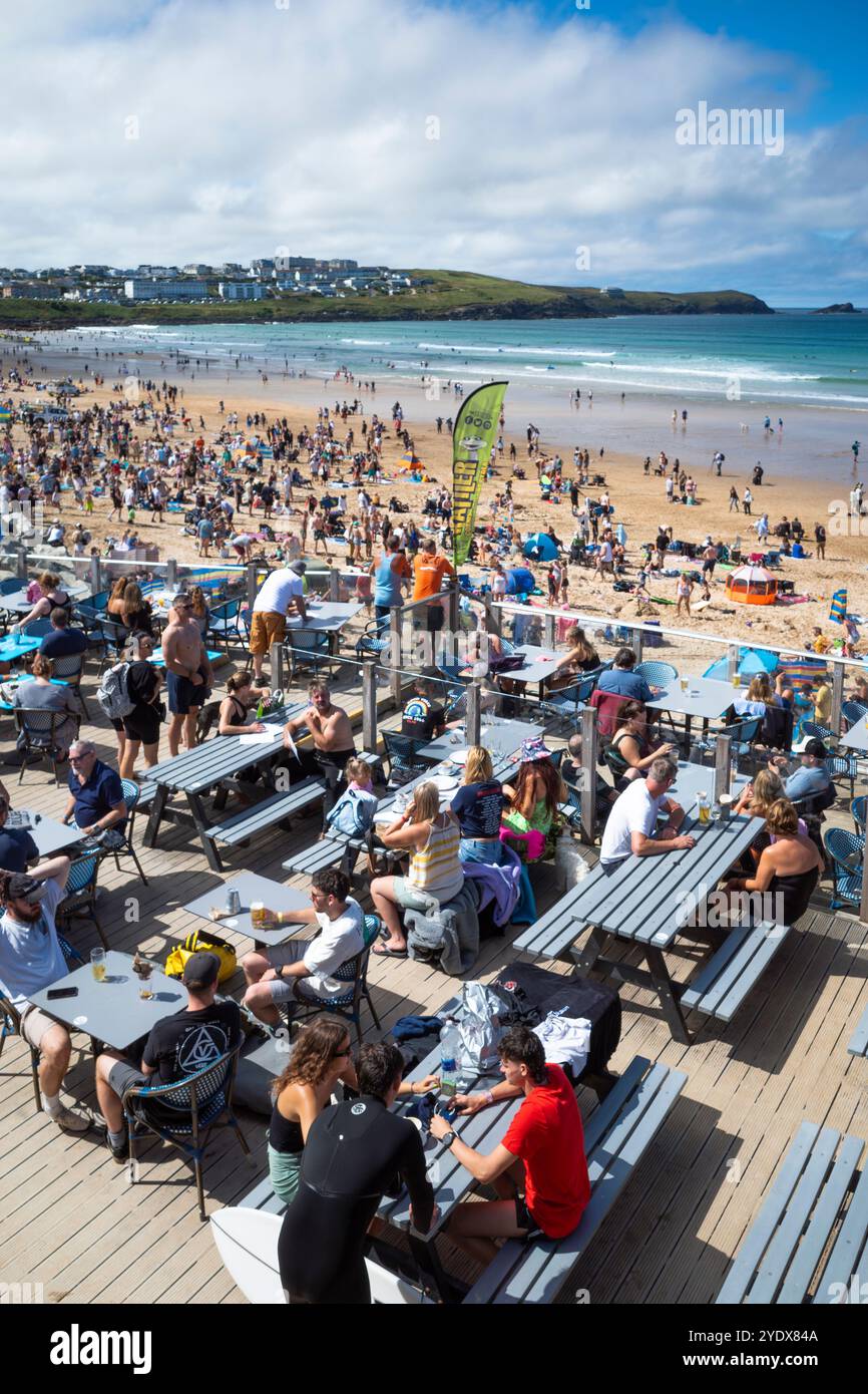 Holidaymakers enjoying the summer sunshine sitting on the outdoor ...