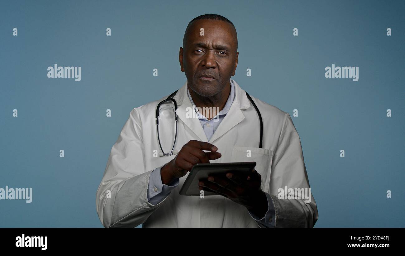 African American male doctor man healthcare worker using digital tablet ...