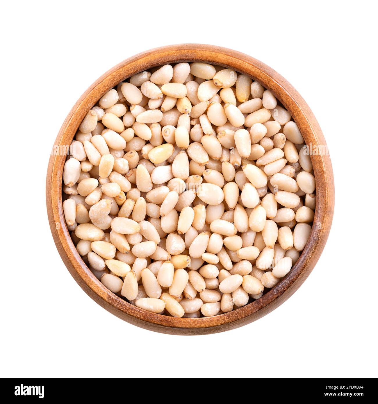 Pine nuts in a wooden bowl, isolated from above. Also known as pinon ...