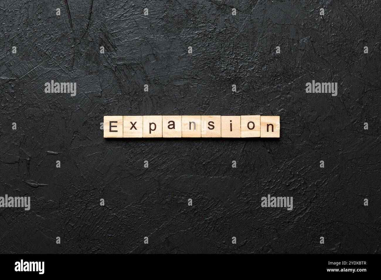 expansion word written on wood block. expansion text on table, concept ...