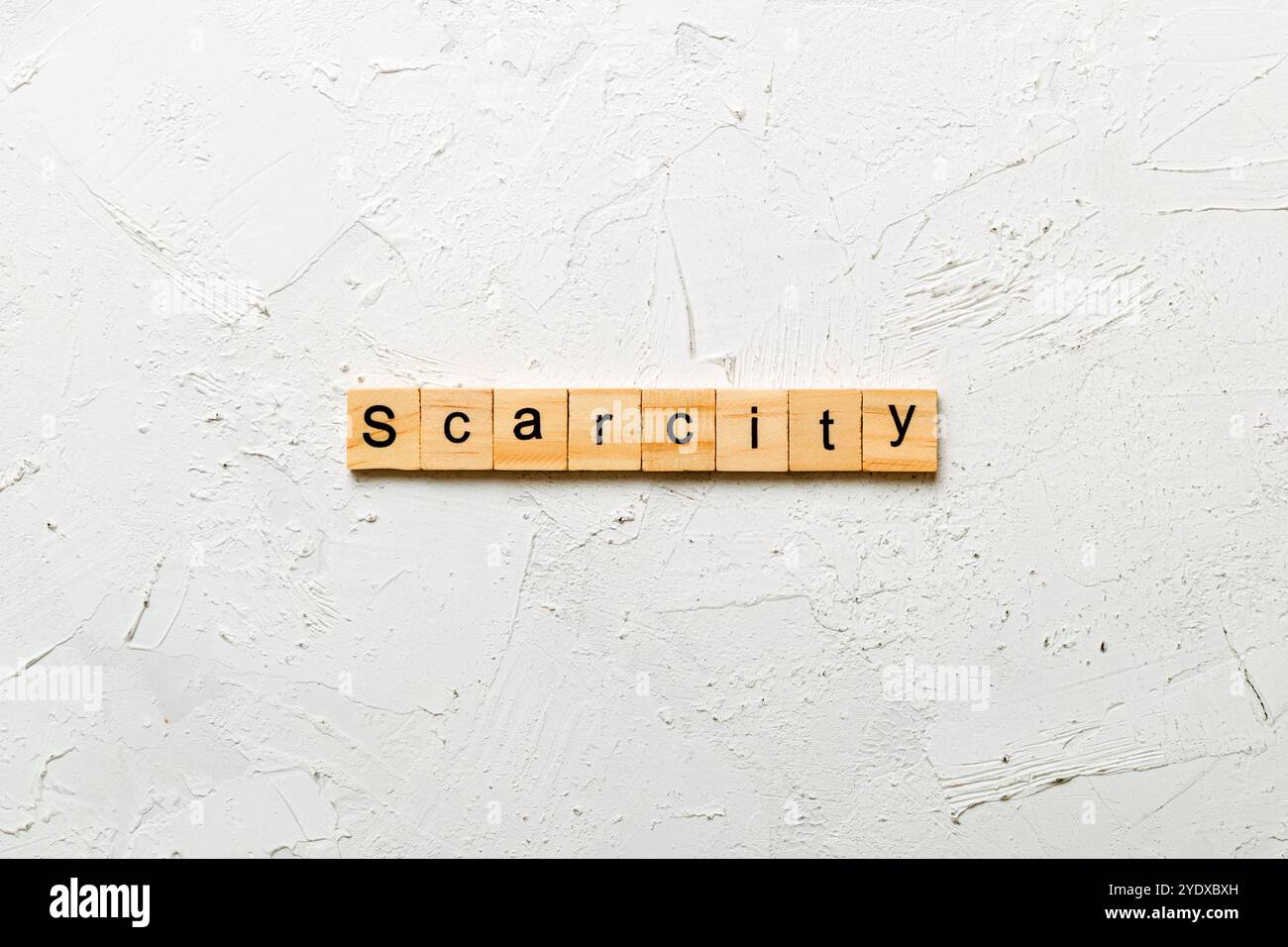 scarcity word written on wood block. scarcity text on cement table for ...