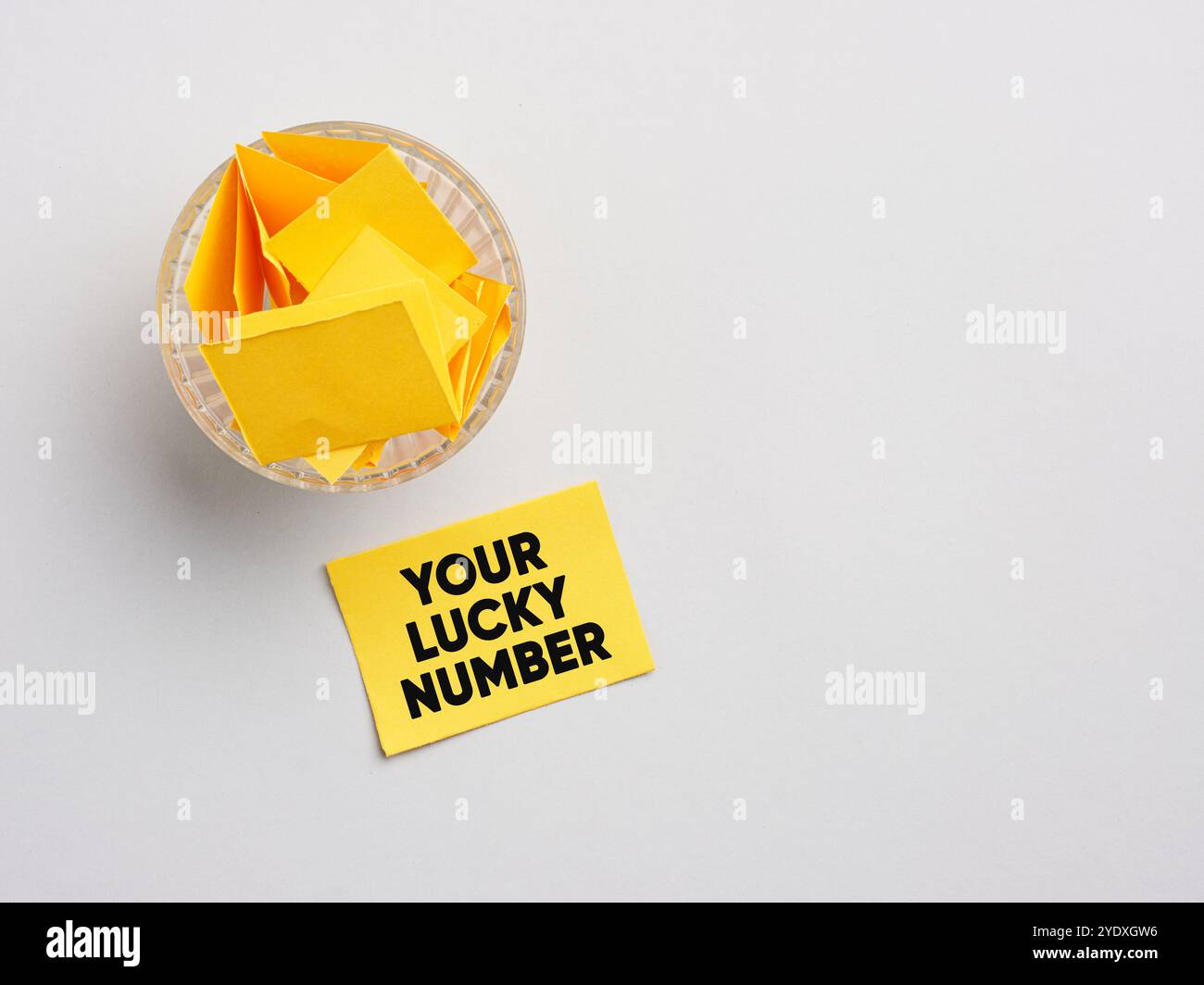 Lottery ticket with the message your lucky number near a glass bowl ...
