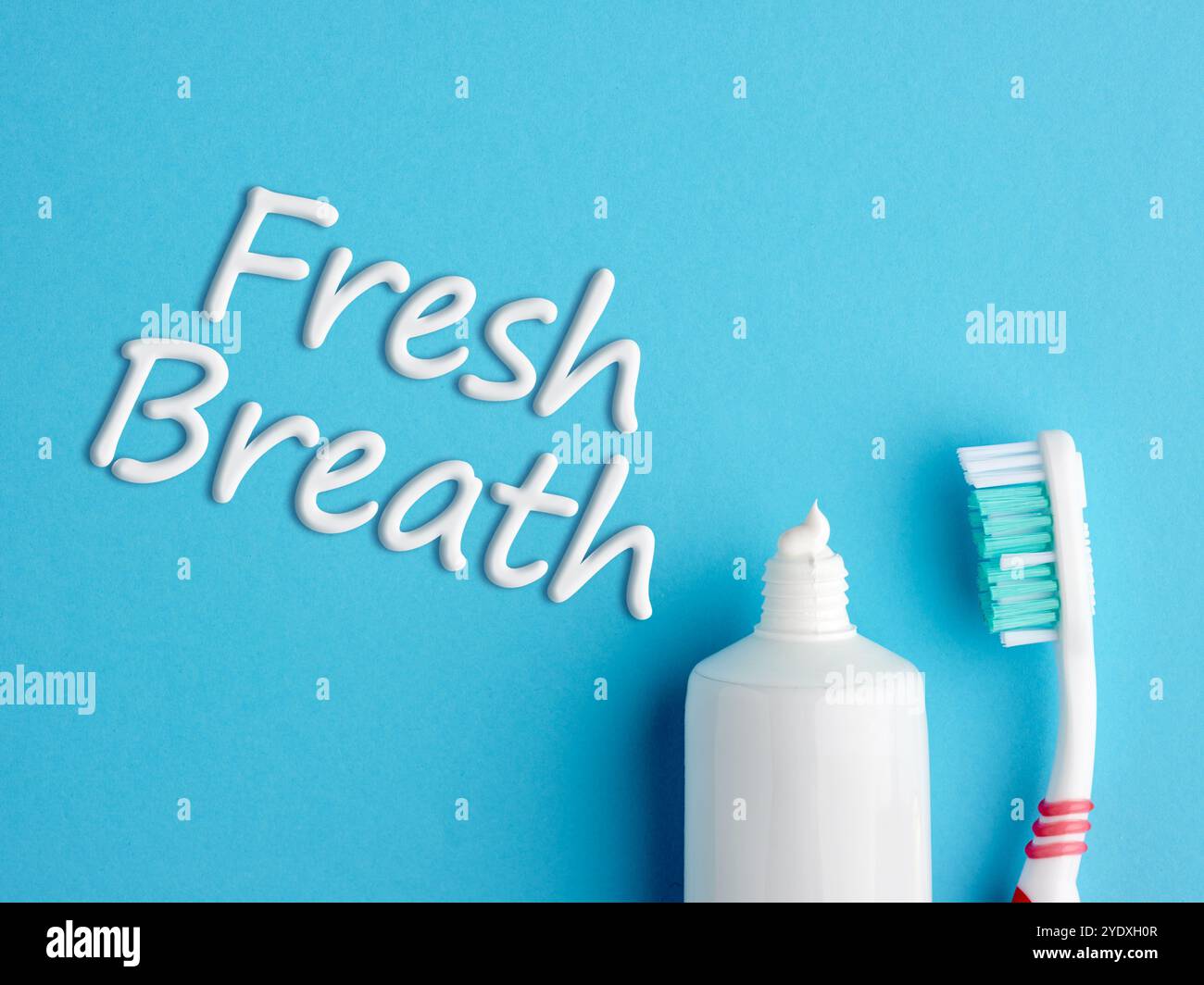 The word fresh breath written with toothpaste on blue background ...