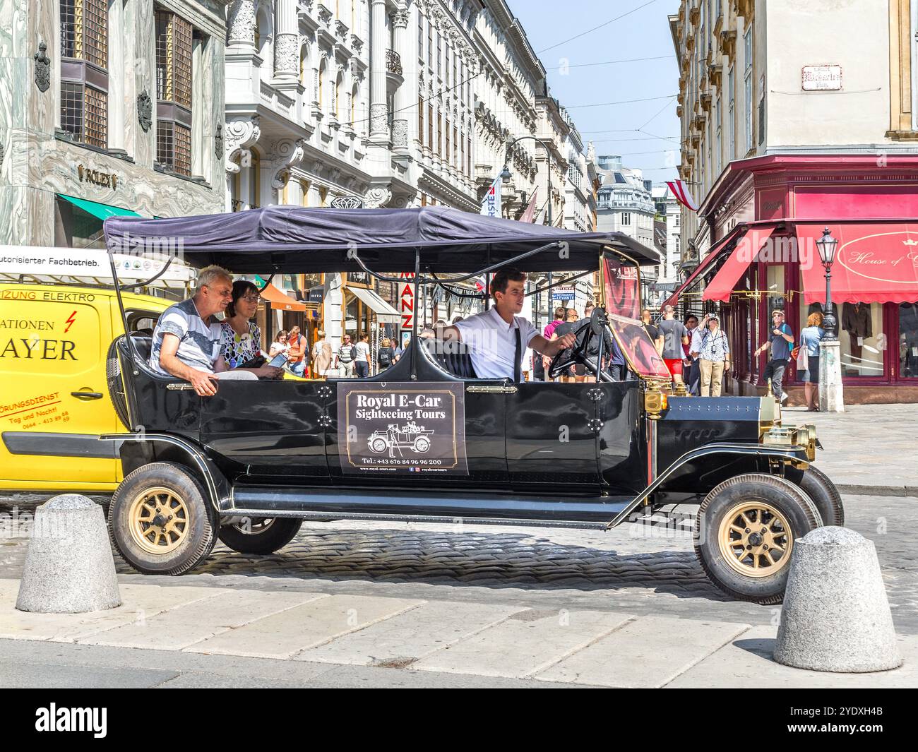 Couple in an electric-powered "Royal e-Car" touring the city center ...