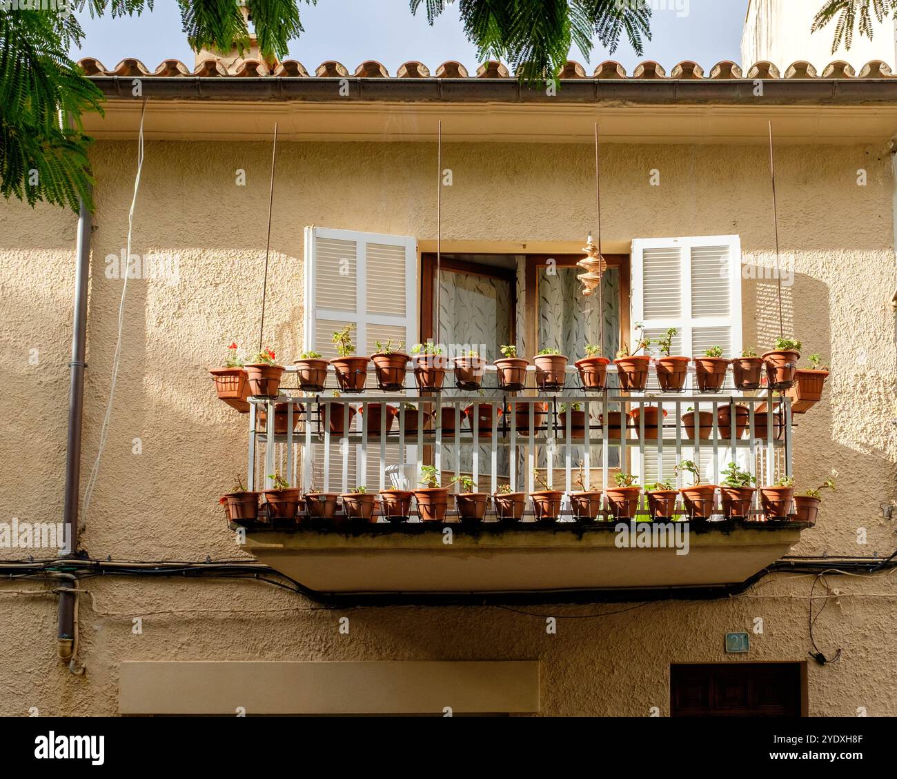 Looking up towards a first floor Mediterranean cottage that has open ...