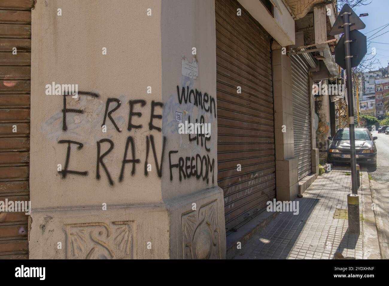 The protest writing "Free Iran" and "Woman Life Freedom" on the wall at ...