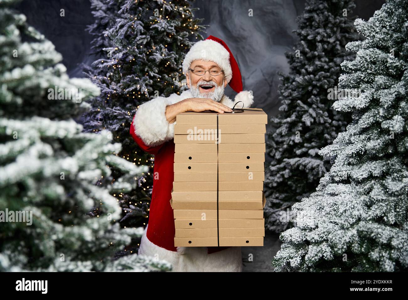 Santa Claus smiles widely while carrying a tall stack of boxes in a ...