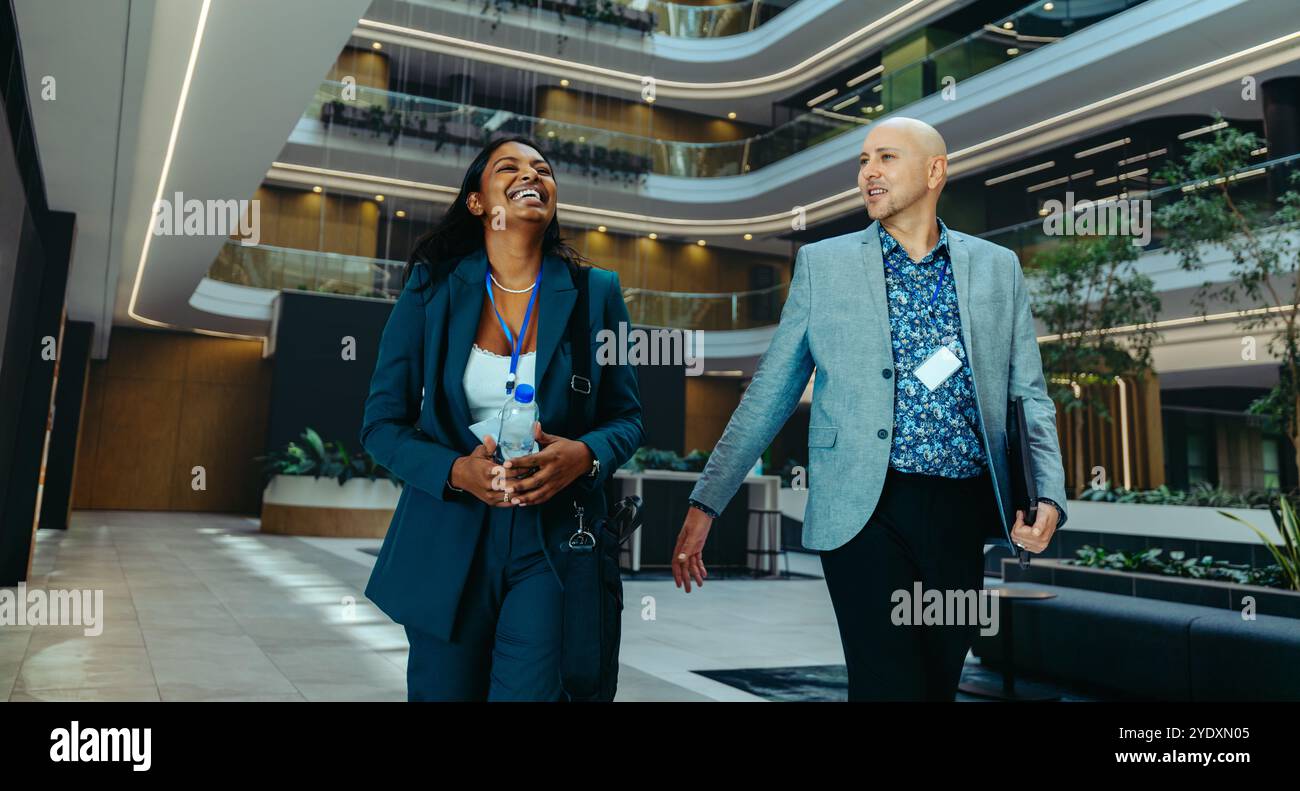 Successful accountants walking through a modern office, reflecting on ...