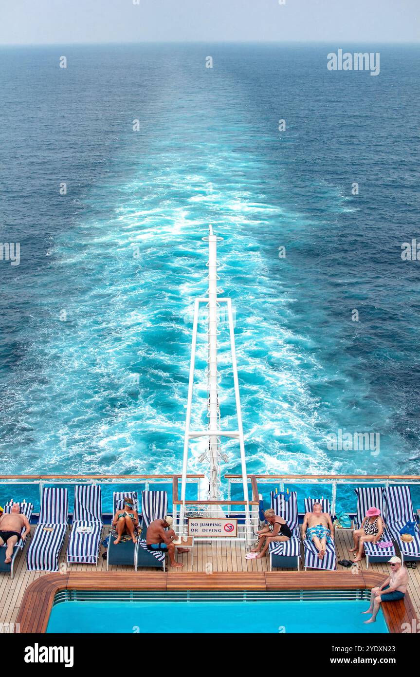 Dubai, UAE - October 17, 2016: Passengers relax on a cruise ship deck, enjoying the ocean view ...