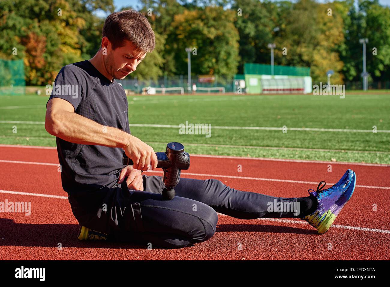 Athlete using handheld massage gun hi-res stock photography and images ...