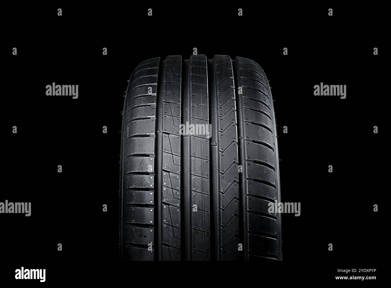 Front view of new summer car tire with symmetrical tread on black background Stock Photo - Alamy