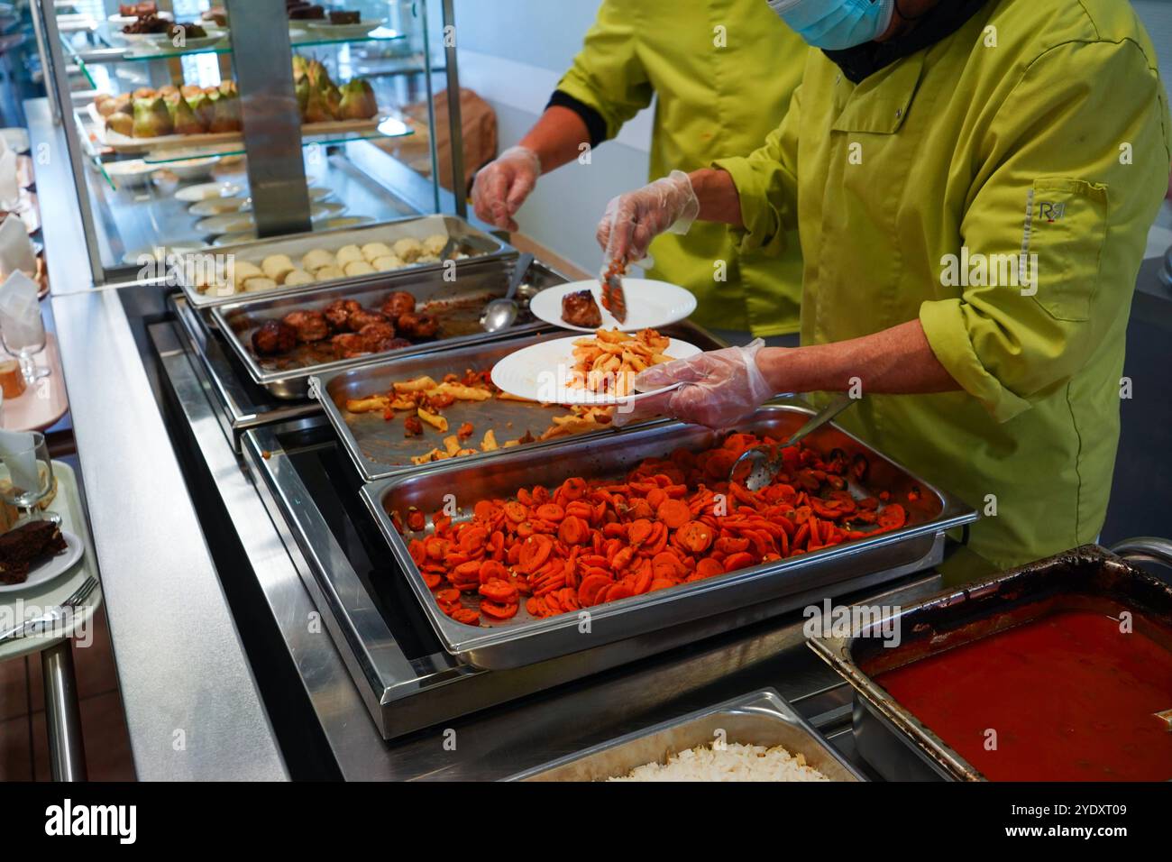 Disabled workers preparing meals for users and supervisors of the ESAT ...