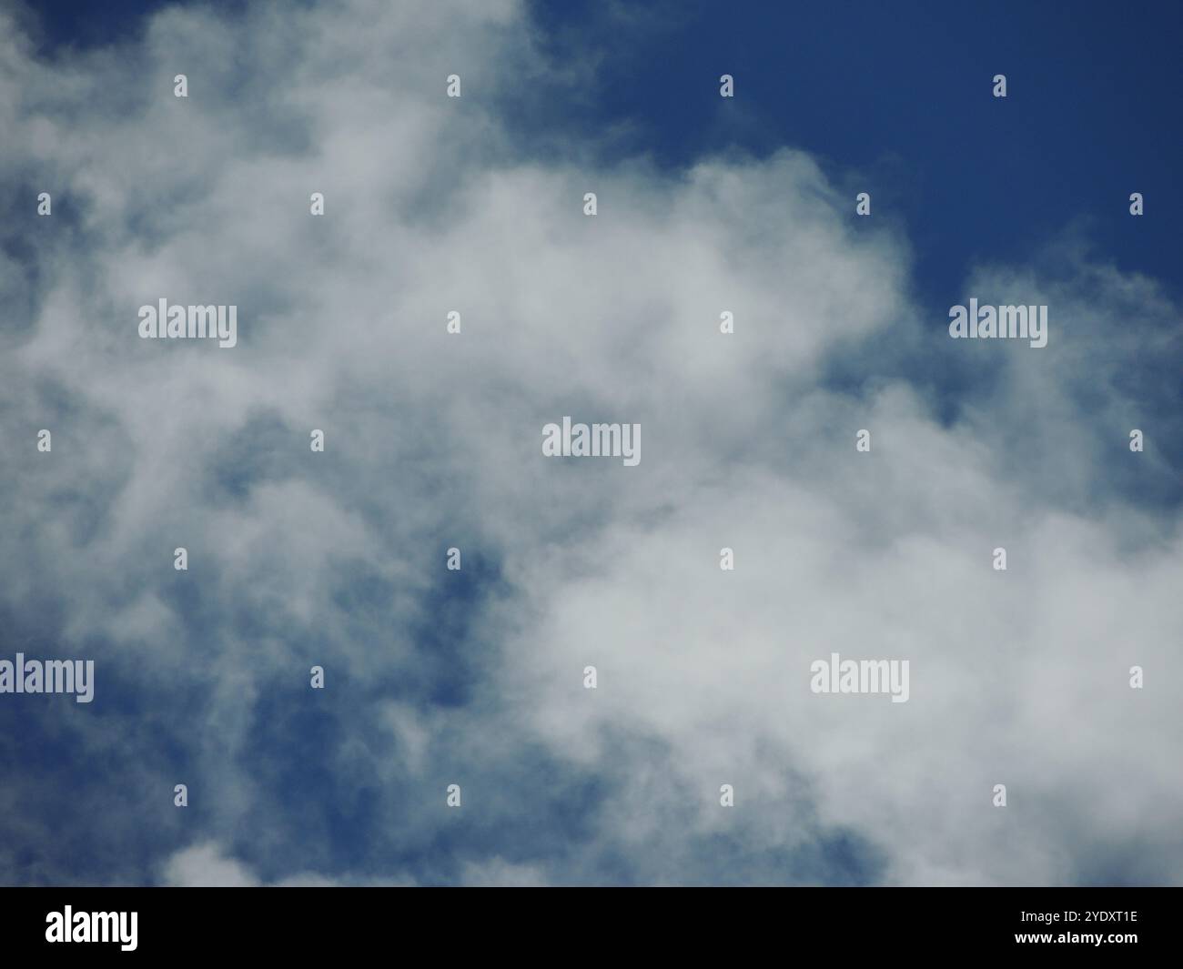 white cumulus cloud on blue sky in blurry focus as natural airy texture ...
