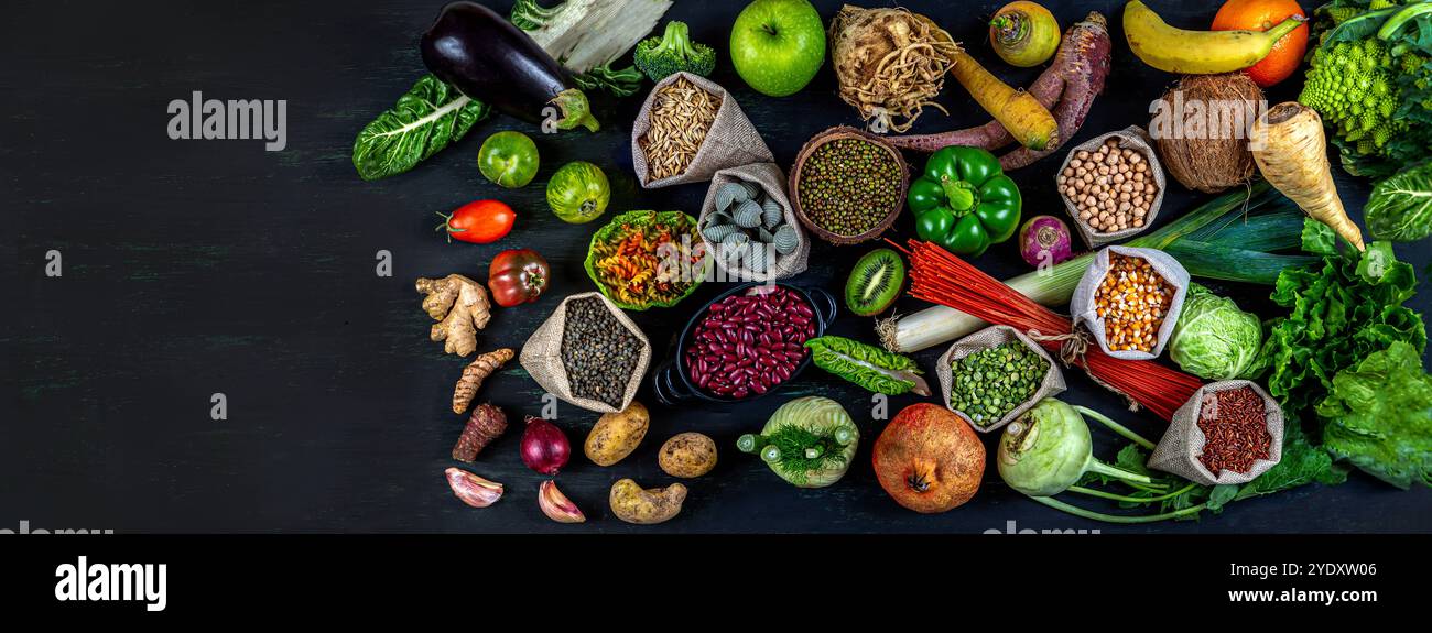 Panoramic view of fruits and vegetables, pasta on a dark background ...