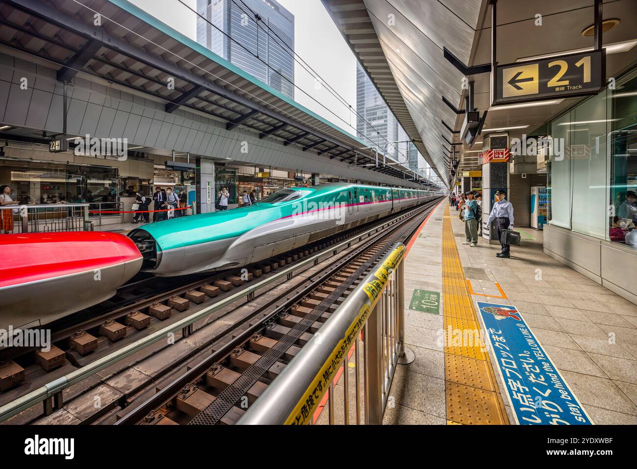 Pair of Japanese bullet trains at the Shinkensen platform in Tokyo ...