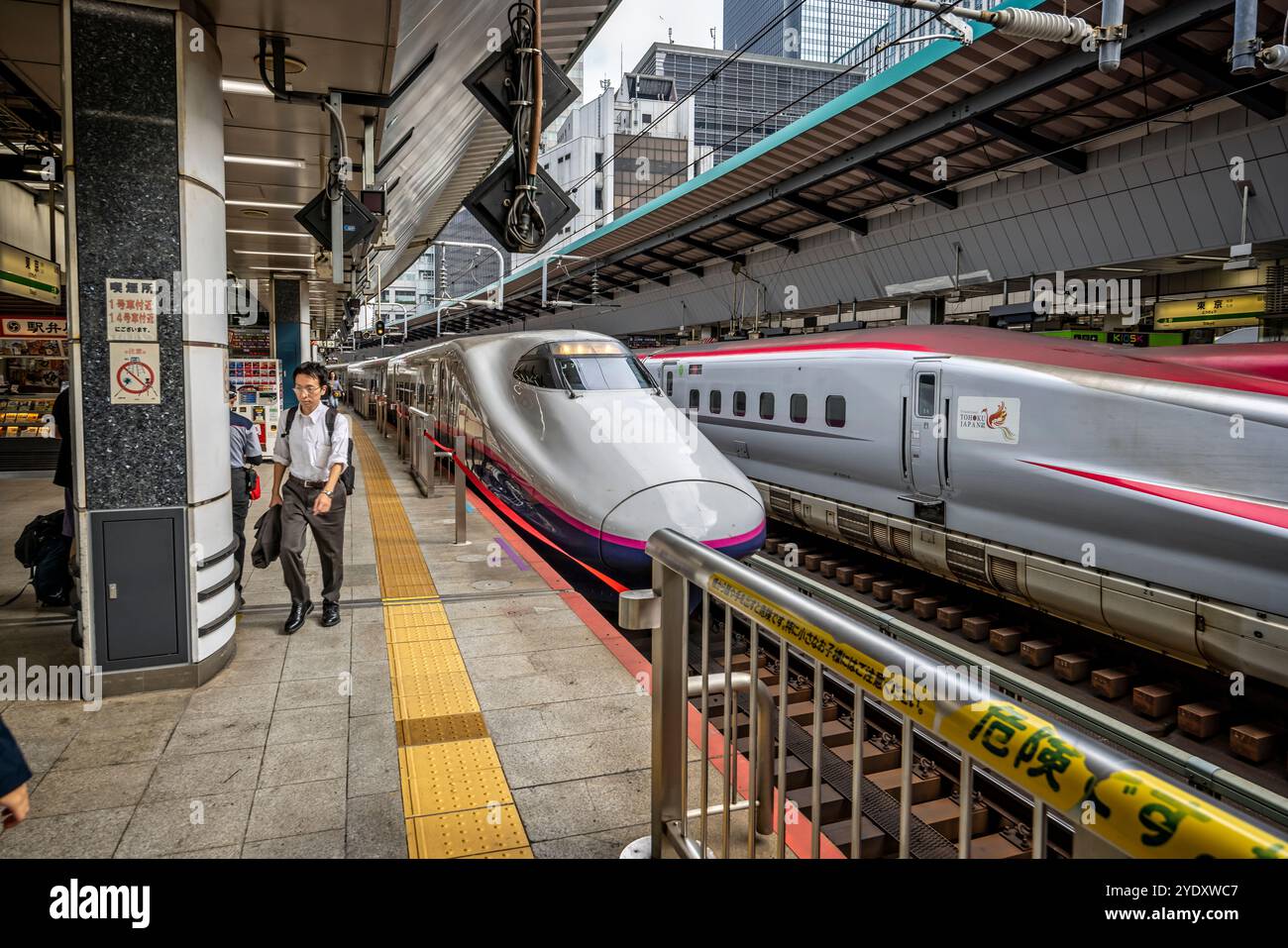 Pair of Japanese bullet trains at the Shinkensen platform in Tokyo ...