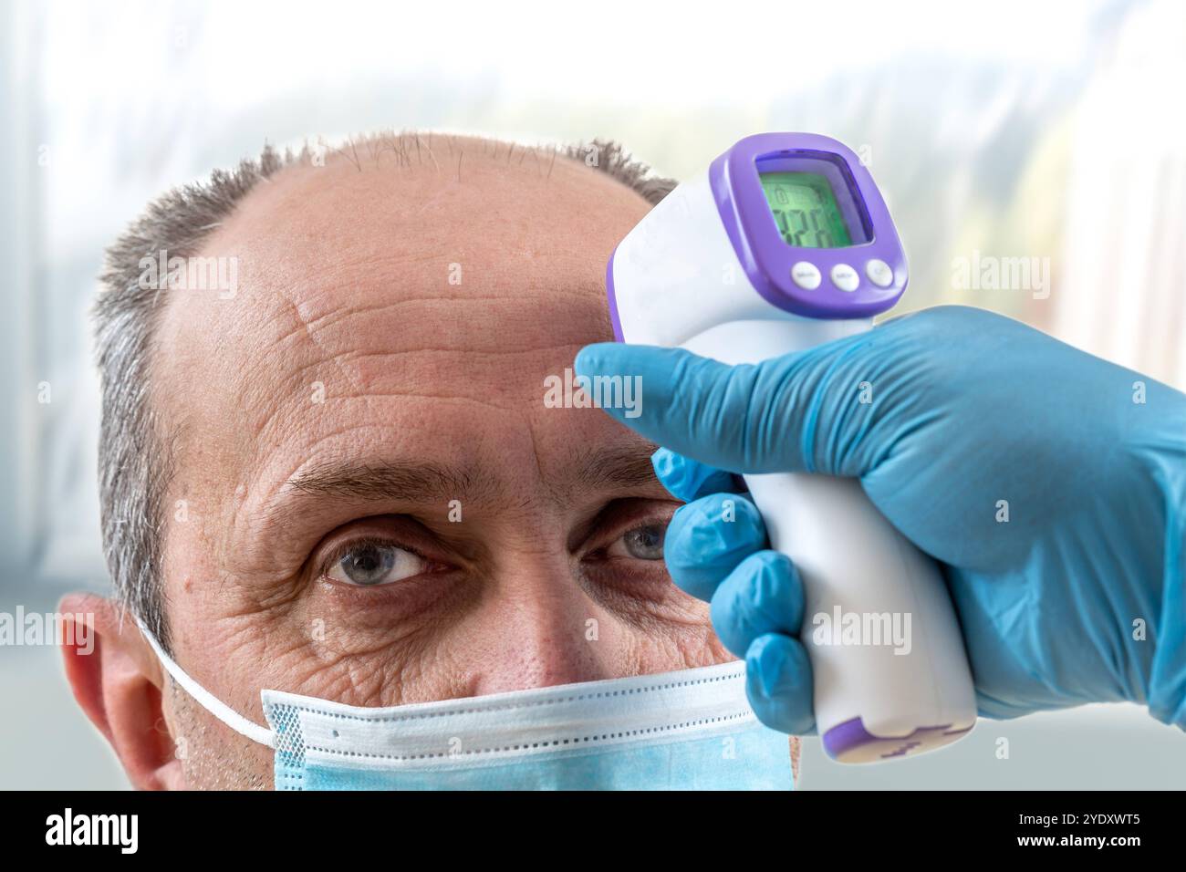 Taking a man s temperature with a digital thermometer. Temperature ...