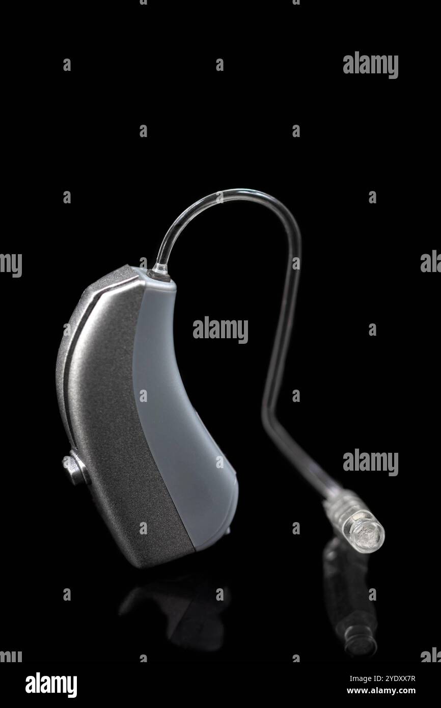Close-up hearing aid on a light background. Hearing aids - main behind ...