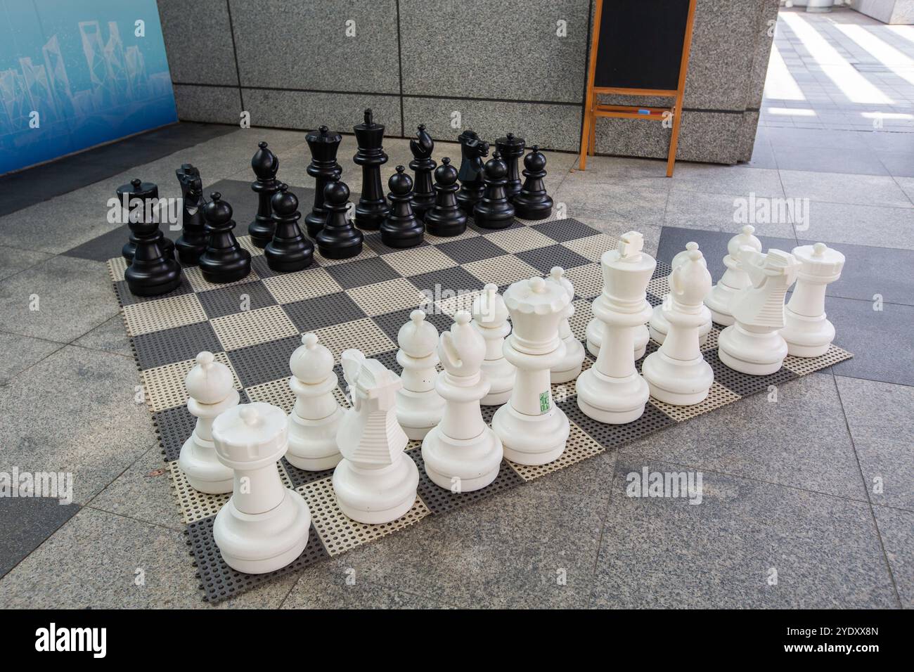 Giant chess game set on floor in public space. Diagonal angle. Ready to ...